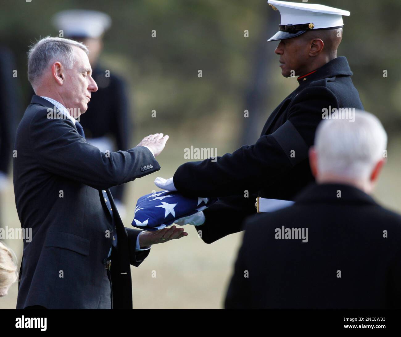 Marine Sgt. Maj. Eric J. Stockton, right, presents a flag to retired ...