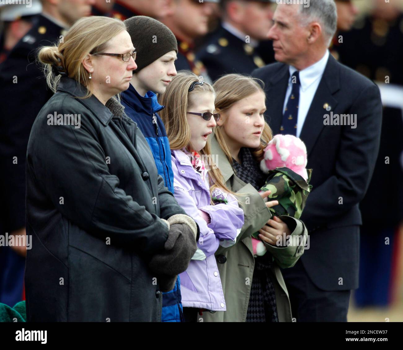 Kelly Hugo, left, stands with family members, including retired Marine ...