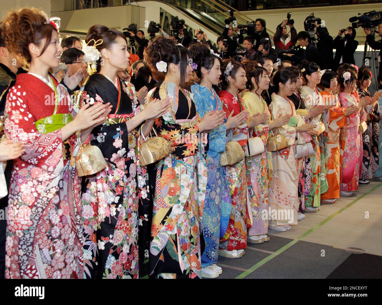 Kimono-clad female workers clap their hands as the Tokyo Stock Exchange ...