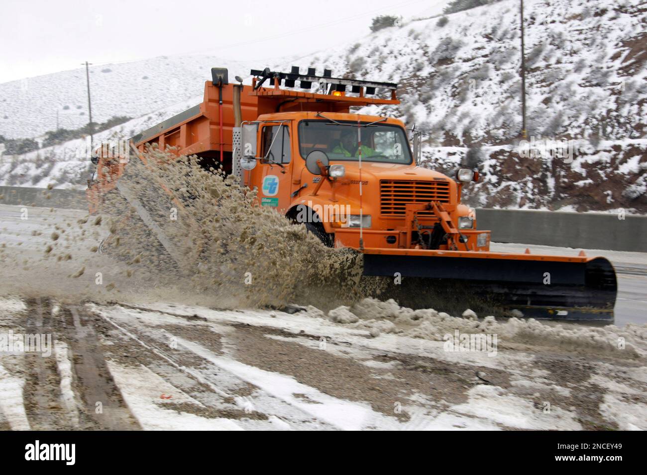 A CalTrans truck plows the road shoulder on Highway 14 near Palmdale ...