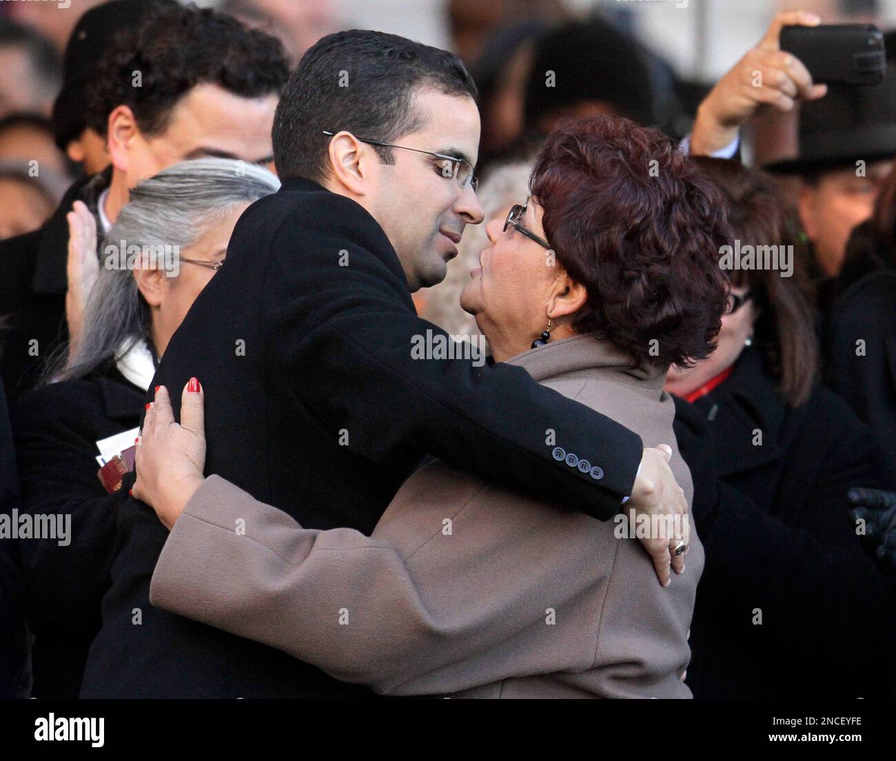 Newly-elected Providence, R.I., Mayor Angel Taveras, left, embraces his ...