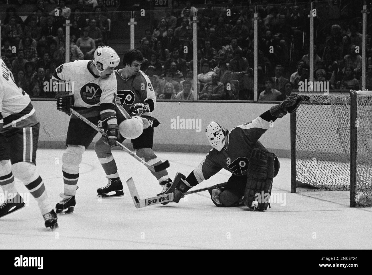 Bryan Trottier of the New York Islanders does a high kick as ...