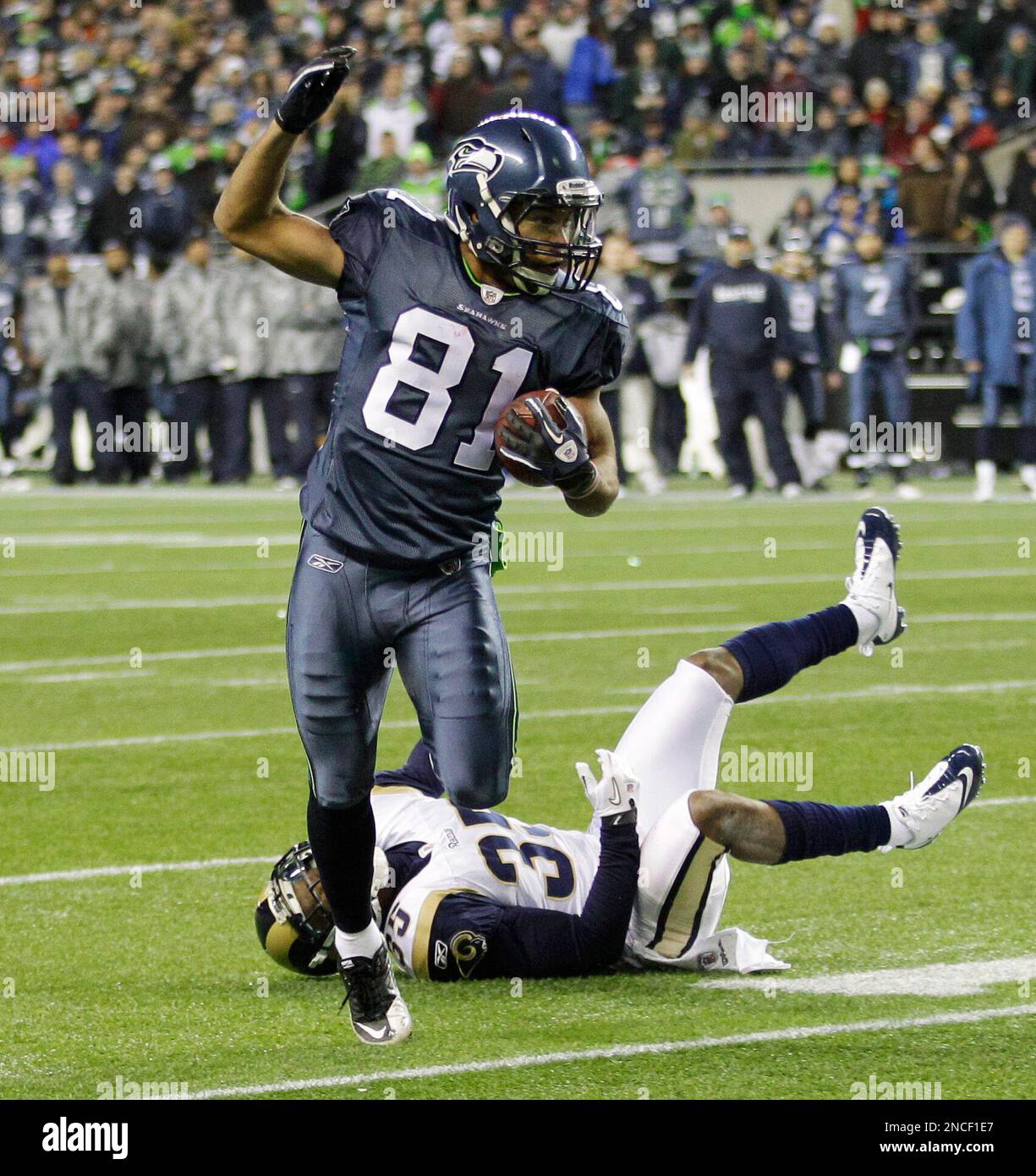 Seattle Seahawks' Golden Tate runs with the ball after evading a tackle ...