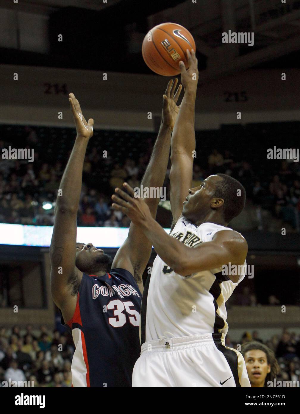 Wake Forest's Travis McKie, right, shoots over Gonzaga's Sam Dower ...