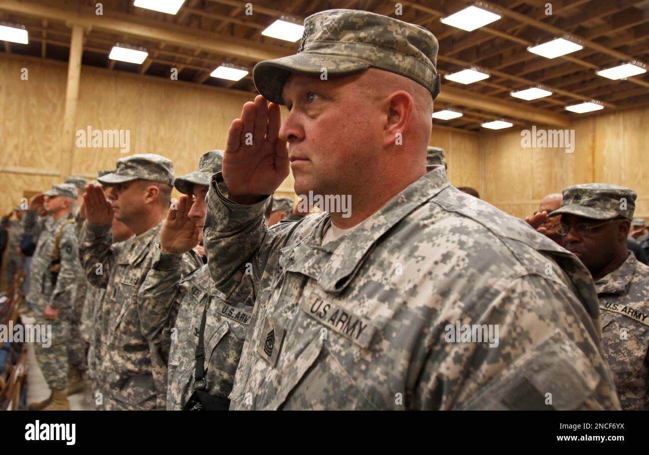 U.S. Army soldiers salute during a handover ceremony of a military base ...