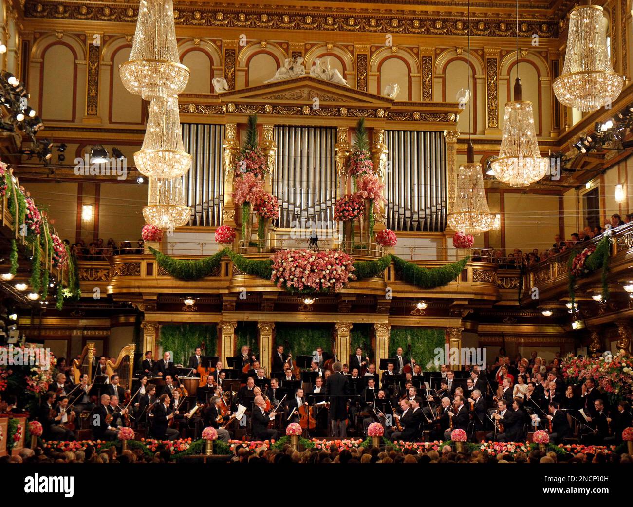 Austrian Maestro Franz Welser-Moest, center, conducts the Vienna ...