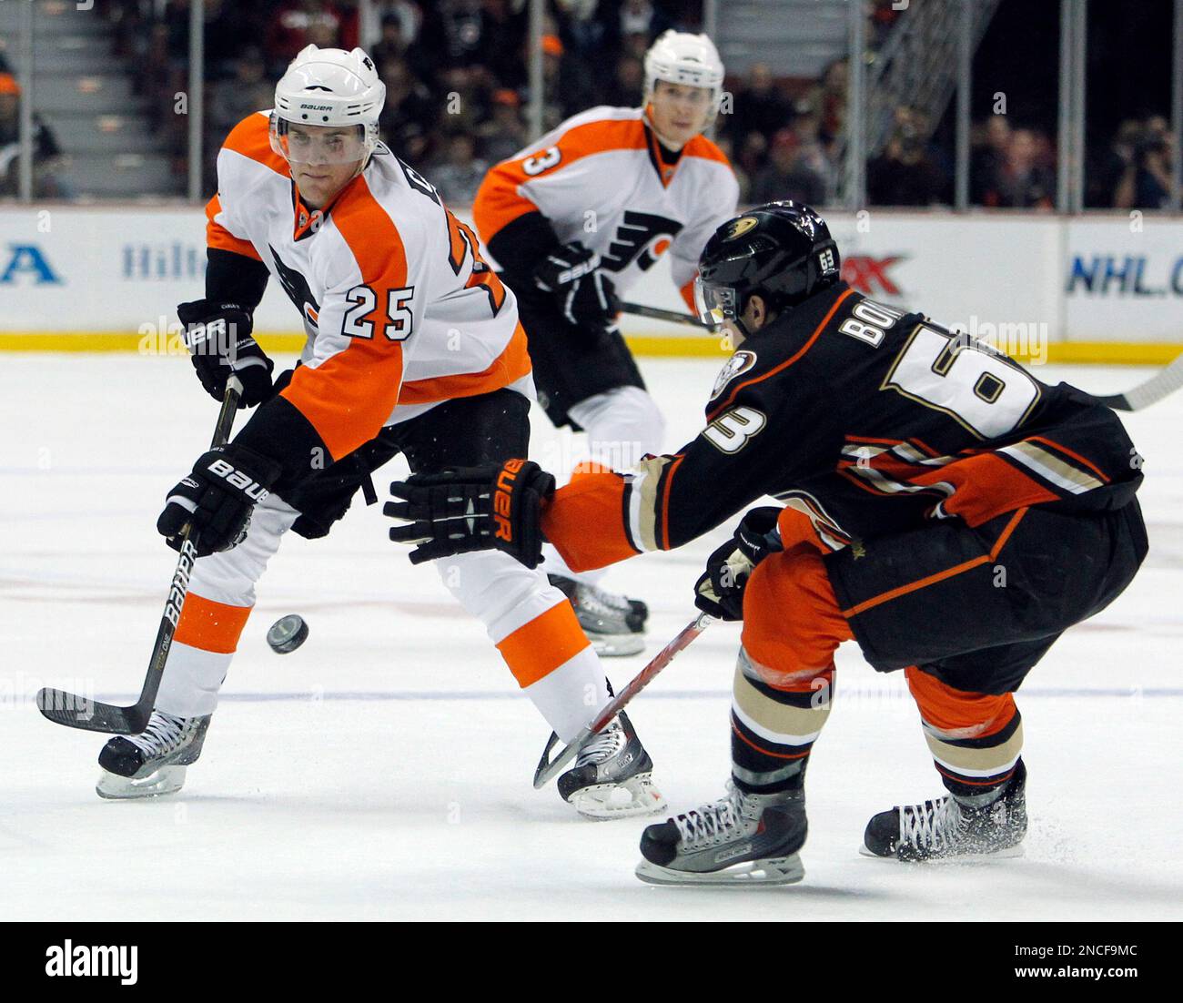 Philadelphia Flyers defenseman Matt Carle (25) flips the puck over ...