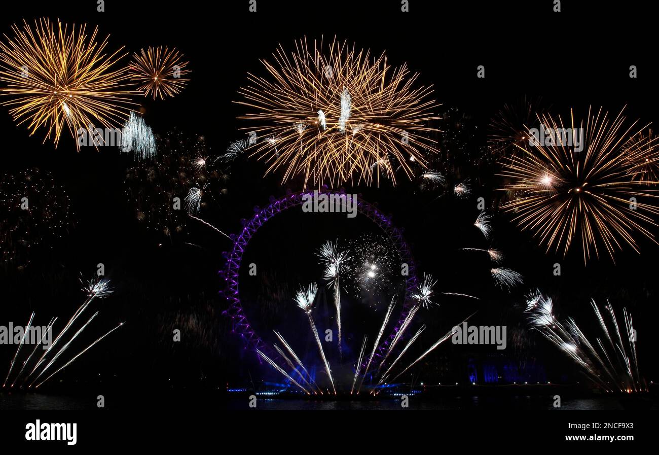 Fireworks explode over the London Eye on the bank of the River Thames ...