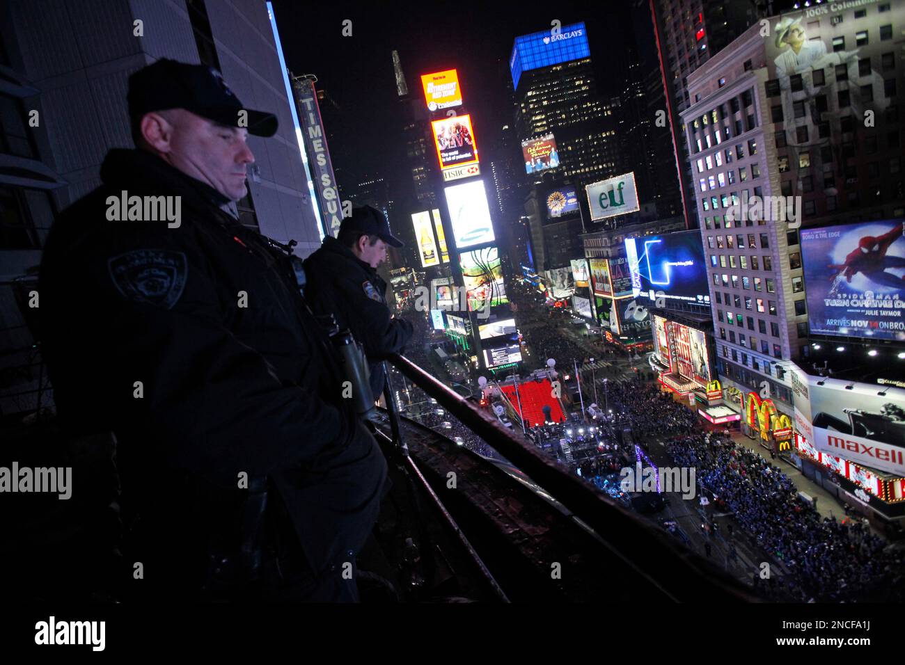NYPD officers monitor the crowd from overhead, Friday, Dec. 31, 2010 in ...