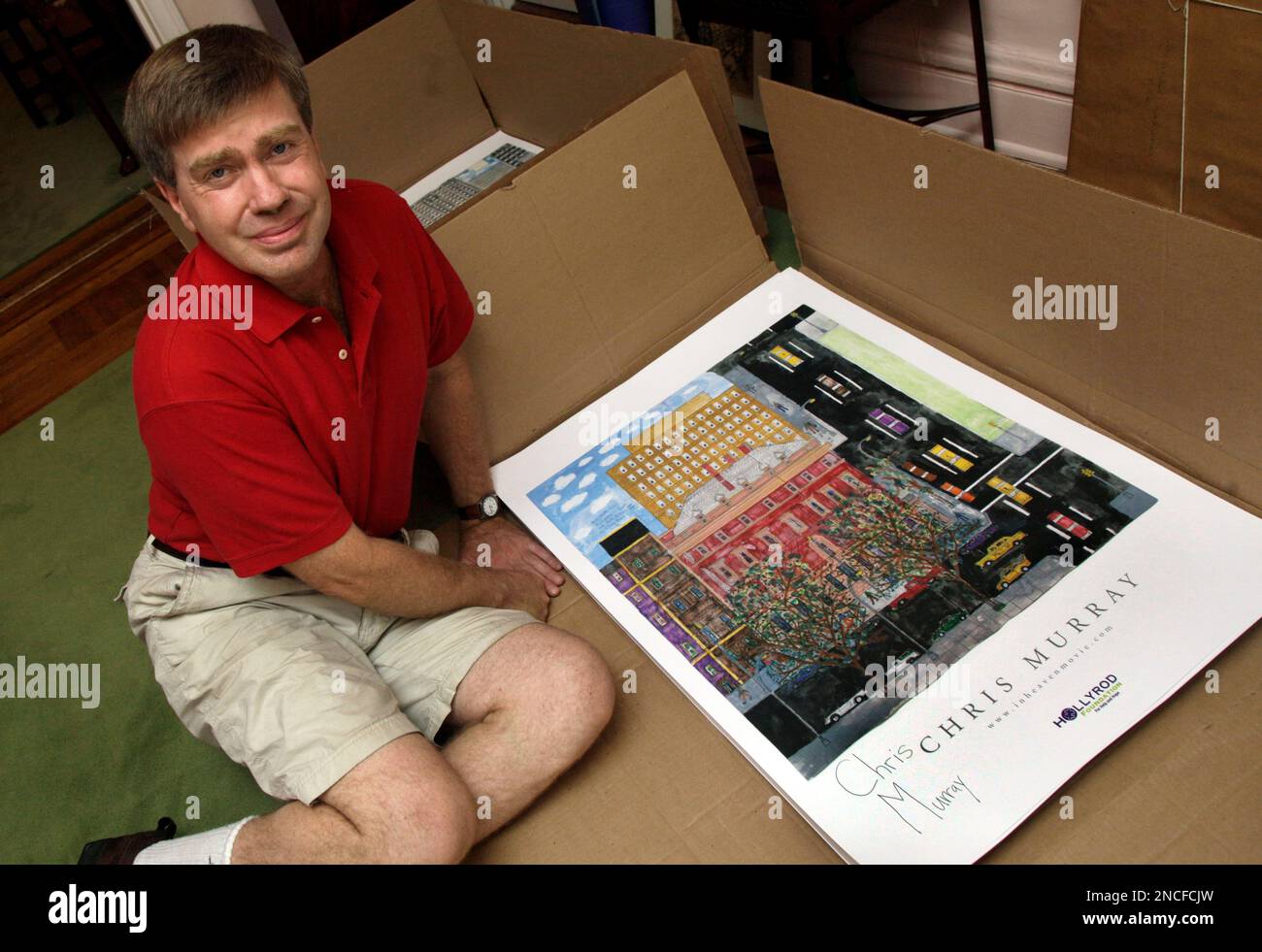 Chris Murray, a 50-year-old autistic, poses by signed posters of his ...
