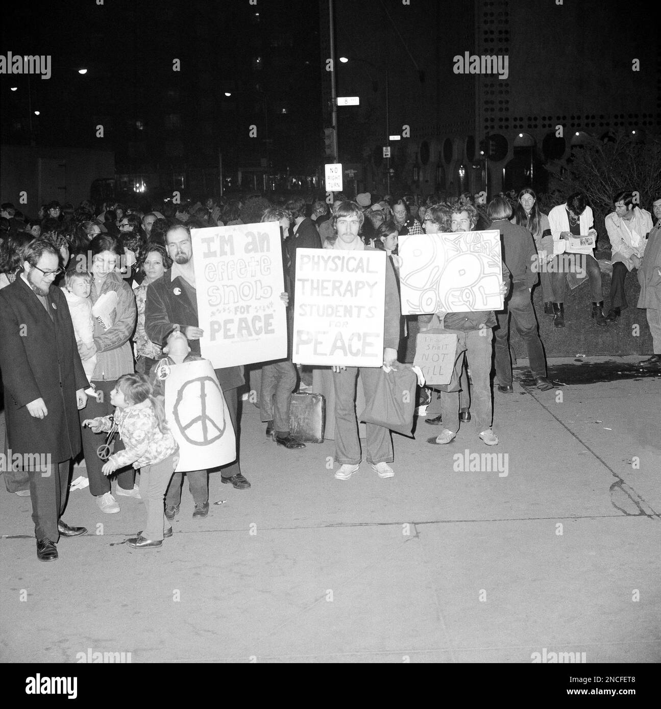 Opponents of the war in Vietnam hold signs before boarding busses at ...