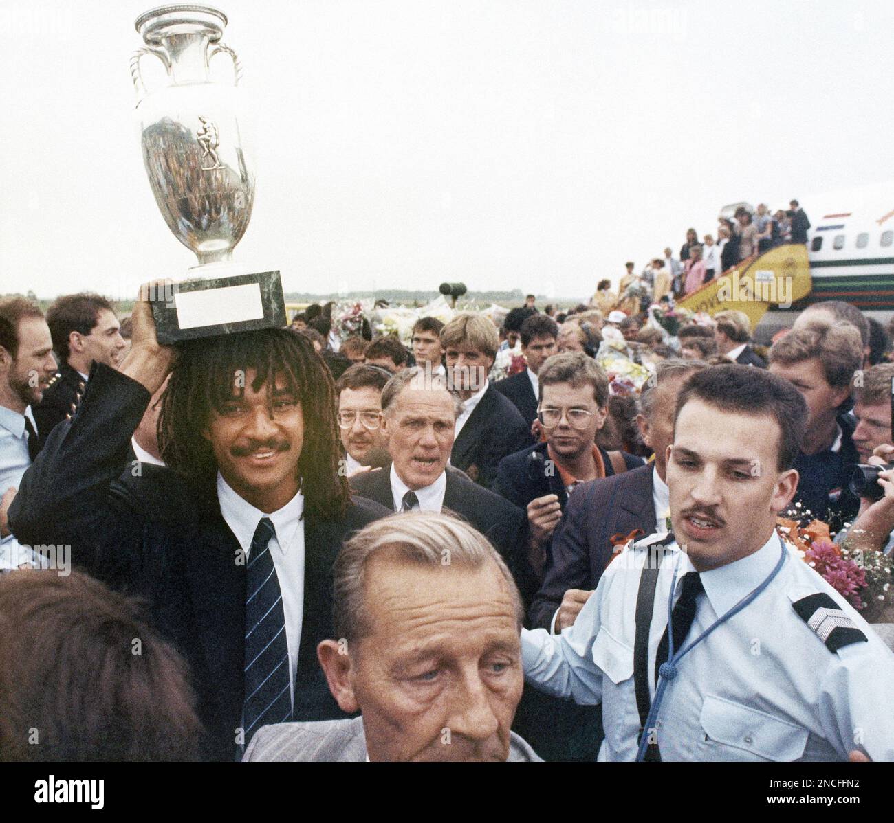 Dutch soccer ace Ruud Gullit is carrying the EUFA Euro Trophy on his ...