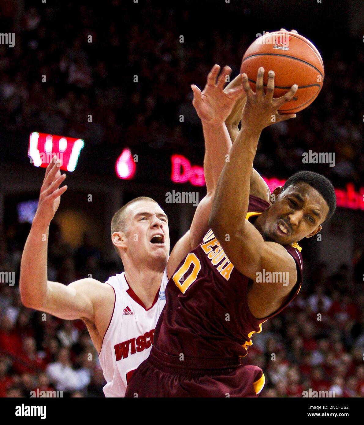 Minnesota's Al Nolen, right, pulls down a rebound against Wisconsin's ...