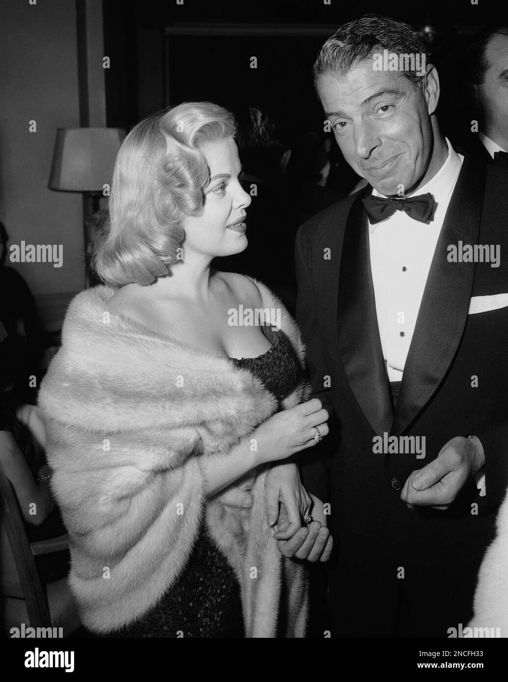 Joe DiMaggio enjoys chatting with movie actress Cleo Moore as they ...