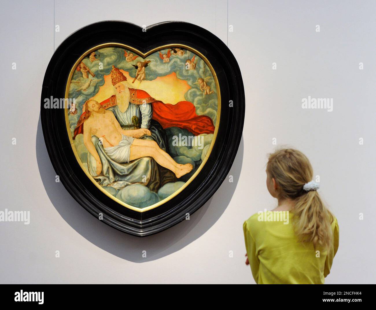 A child stands besides the picture 'The Trinity' (around 1584) of Lucas ...