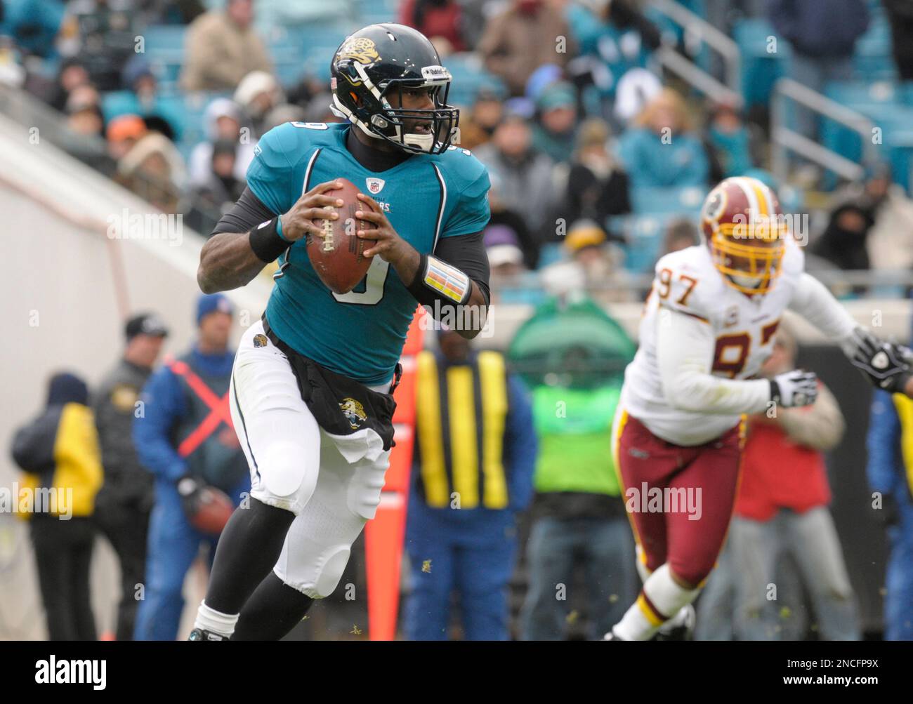 Jacksonville Jaguars quarterback David Garrard (9), left, rolls out ...