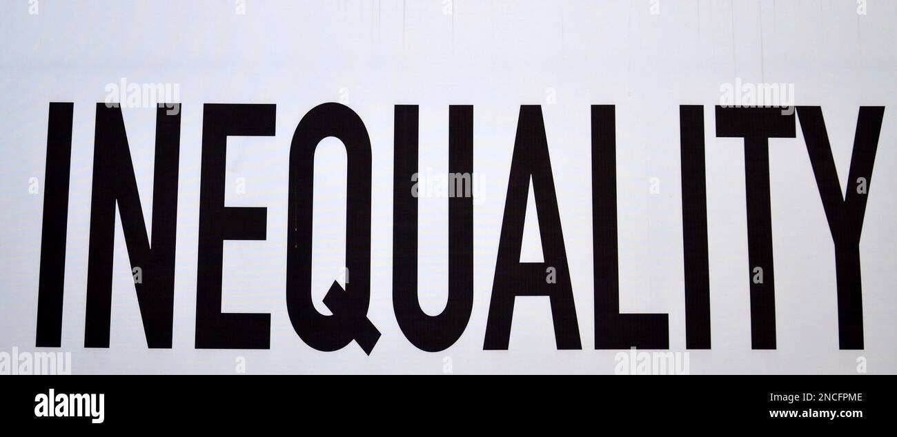 A sign saying: 'INEQUALITY' on a white background Stock Photo - Alamy