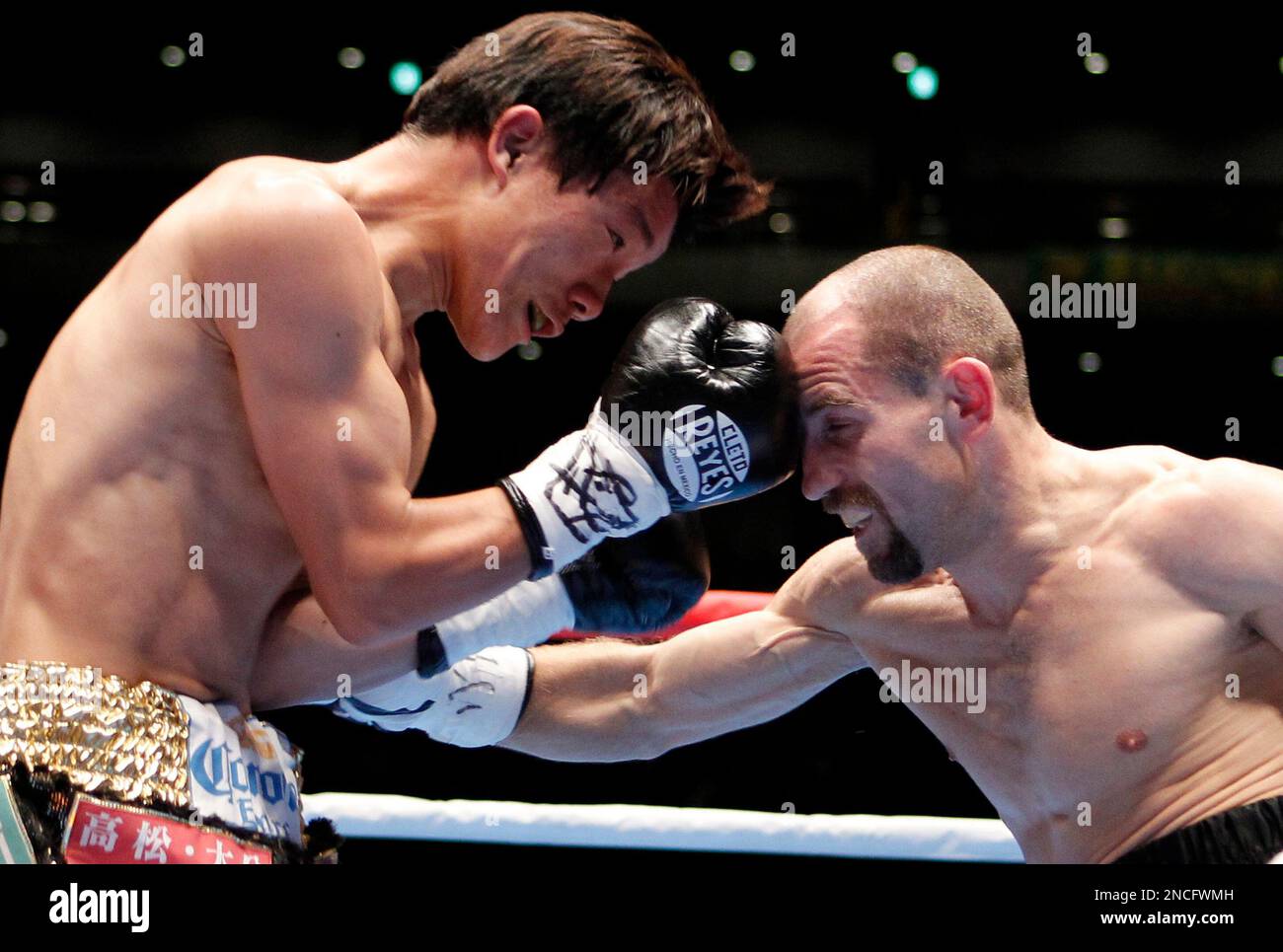 Japanese champion Daiki Kameda, left, and Romanian challenger Silvio Olteanu exchange punches ...