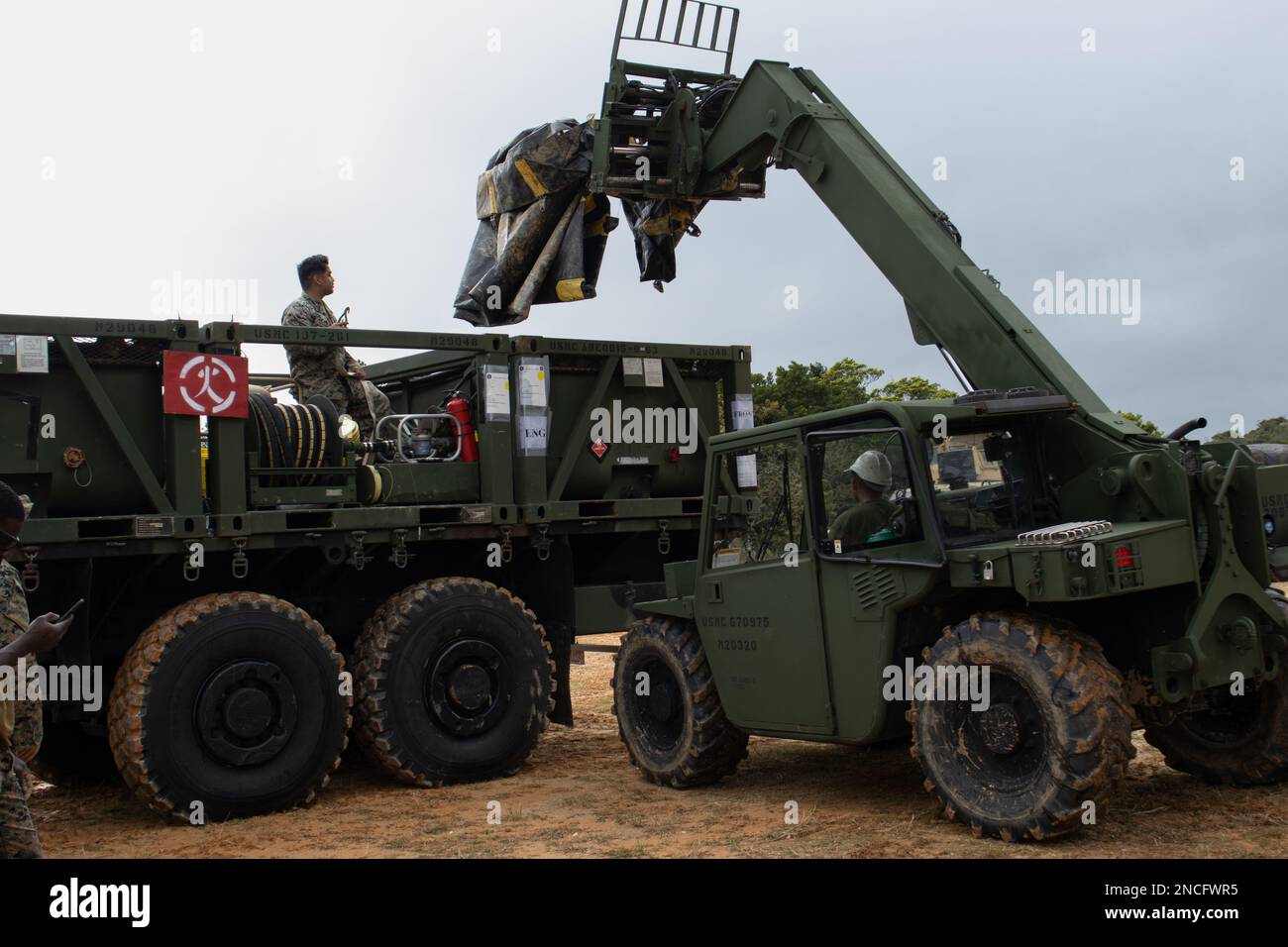 U.S. Marine Corps Lance Cpl. Rafael Herrera, right, an engineer ...