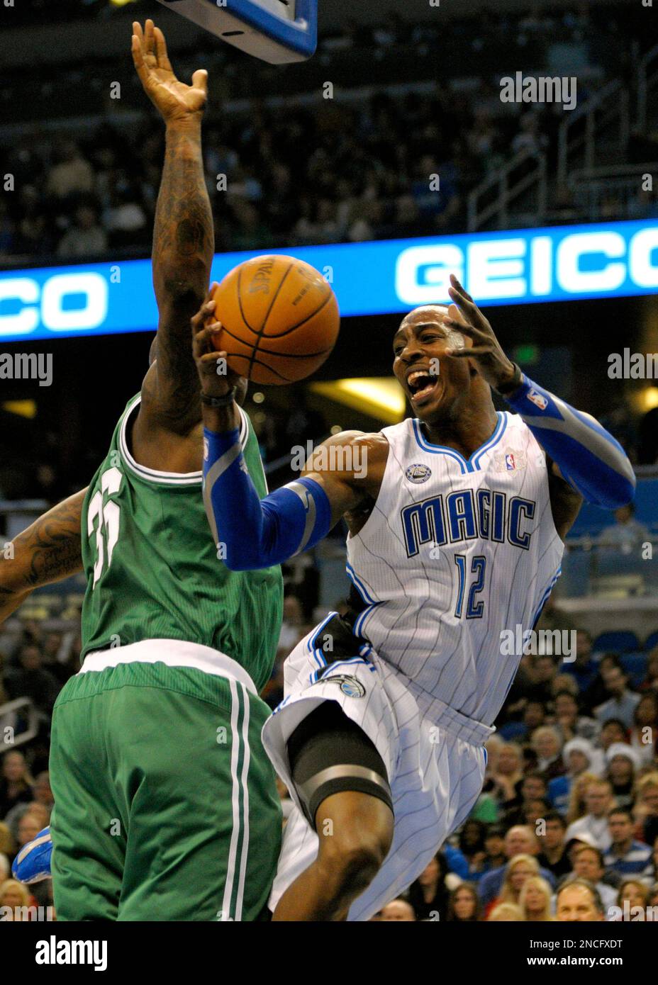 Orlando Magic center Dwight Howard, right, goes up for a shot around ...