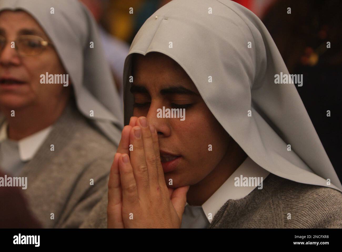 A nuns pray during Christmas morning Mass in the Church of Nativity ...