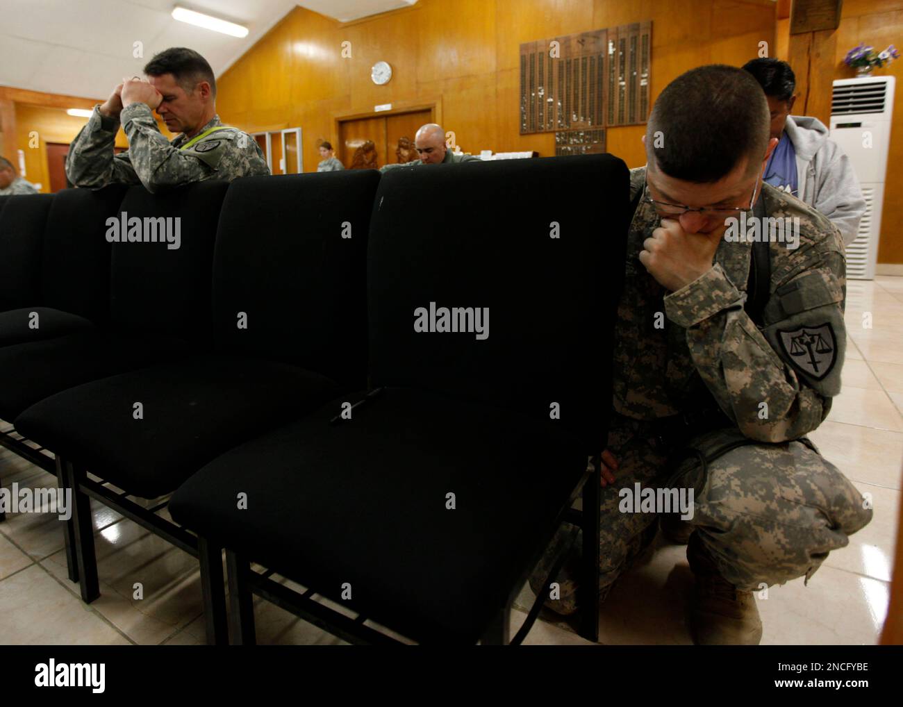 U.S. troops praying during a Christmas Eve mass in a chapel at an ...