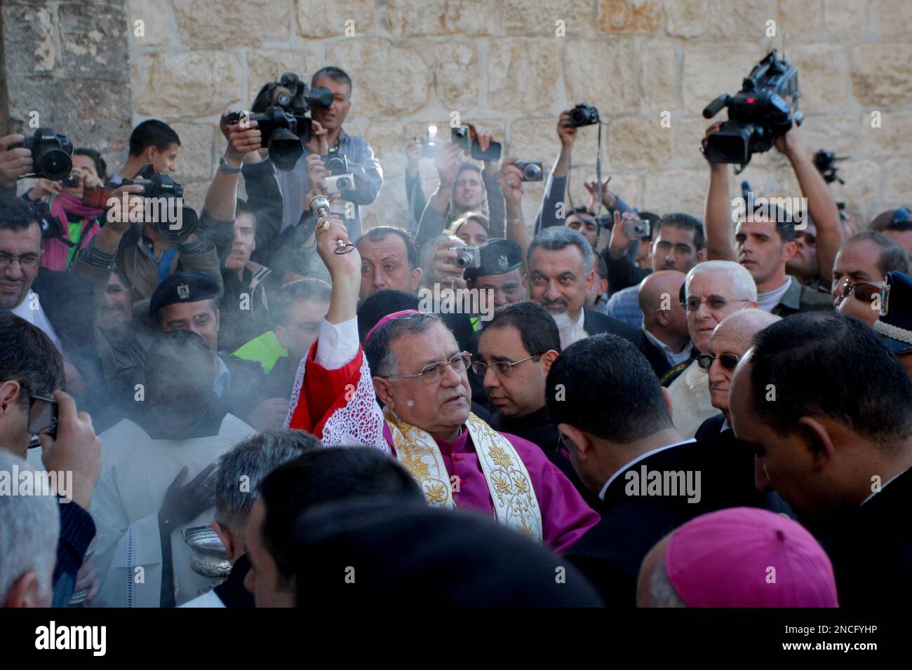 Latin Patriarch of Jerusalem Fouad Twal, center, performs a blessing ...