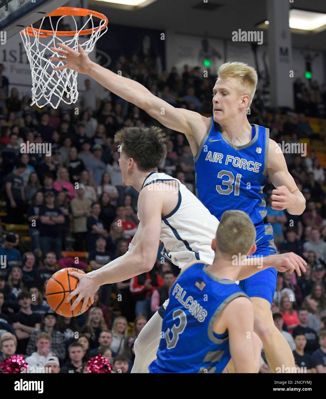 Utah State guard Max Shulga drives to the basket as Air Force guard ...