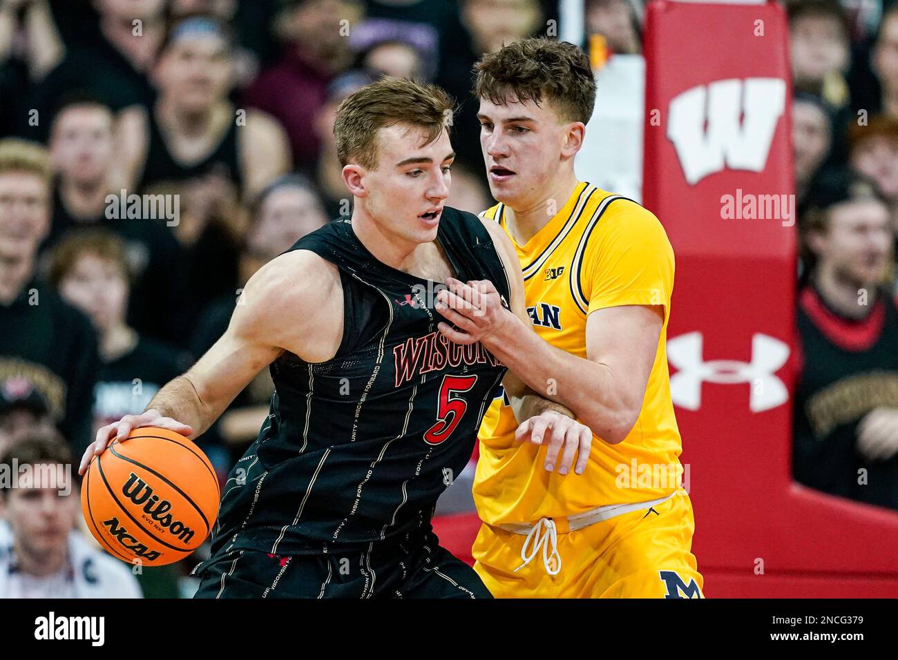 Wisconsin's Tyler Wahl (5) drives against Michigan's Will Tschetter (42 ...