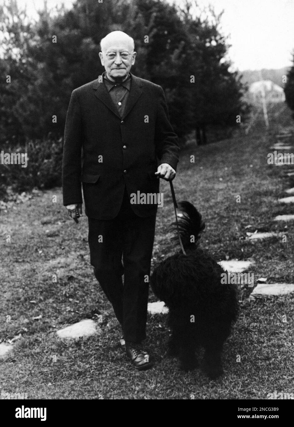 Former German Chancellor Heinrich Bruening walks his dog at his home in ...