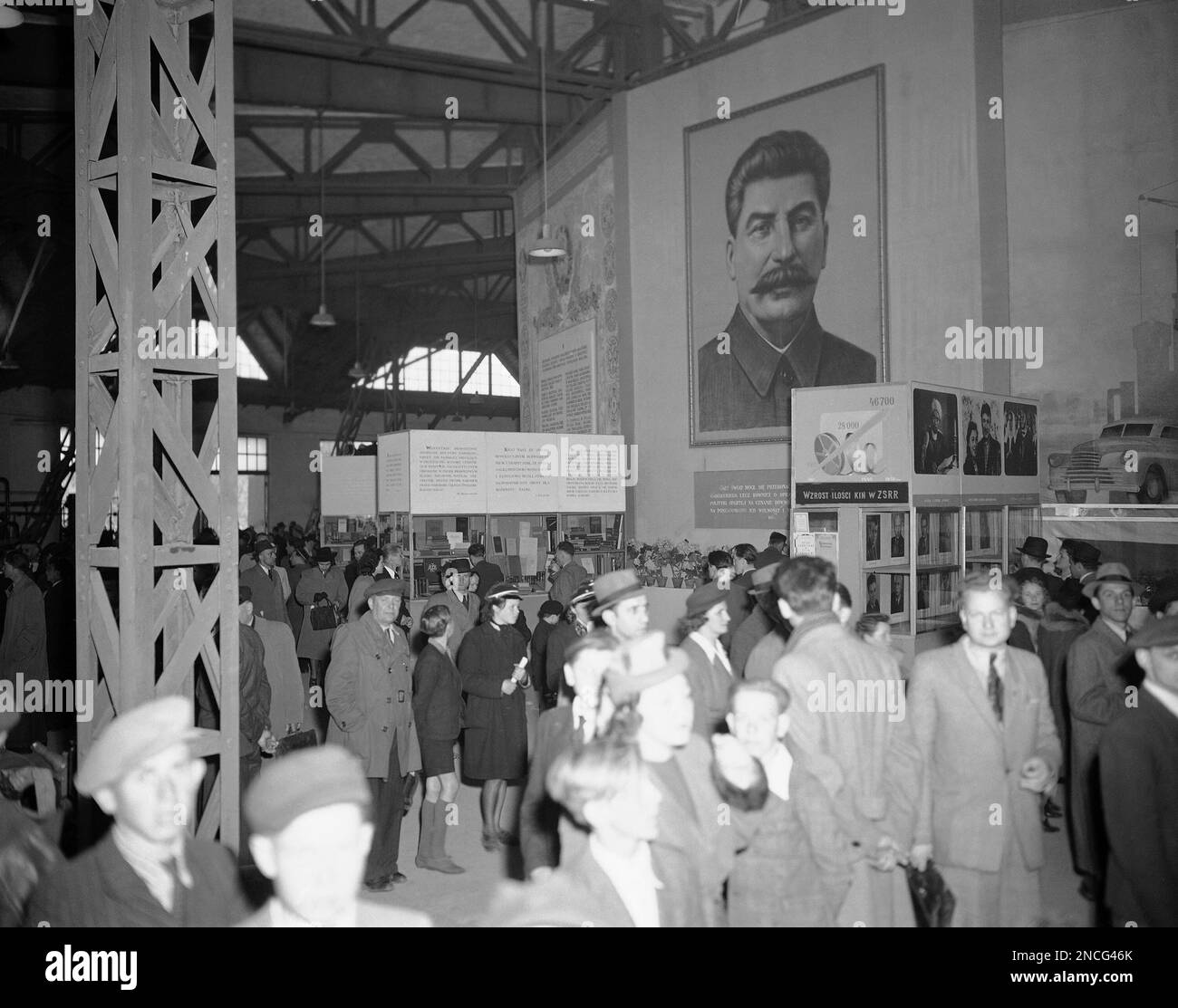 A huge portrait of Premier Josef Stalin of Russia overlooks crowds ...