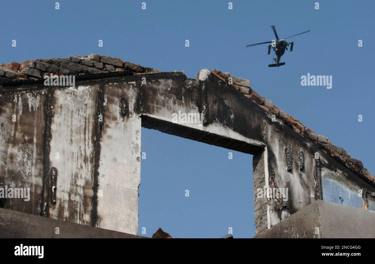 A South Korean military helicopter flies over a house destroyed by last ...