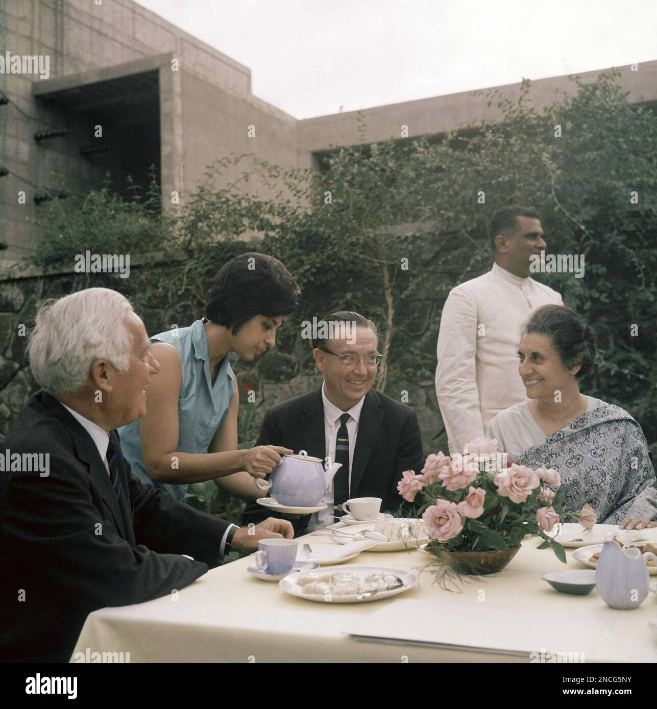 Premier of India Mrs. Indira Gandhi and others seated at a table just ...
