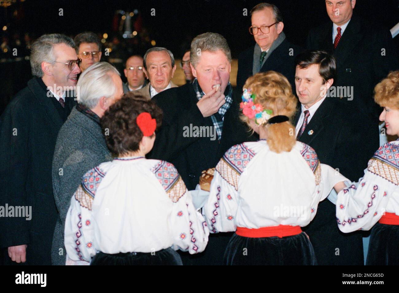 U.S. President Bill Clinton, center, eats some bread and salt, a ...