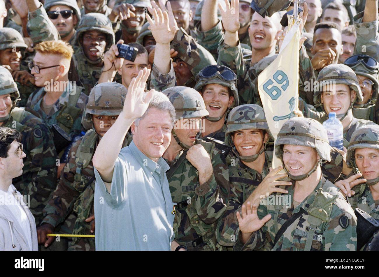 President Bill Clinton is cheered by U.S. soldiers with the First ...