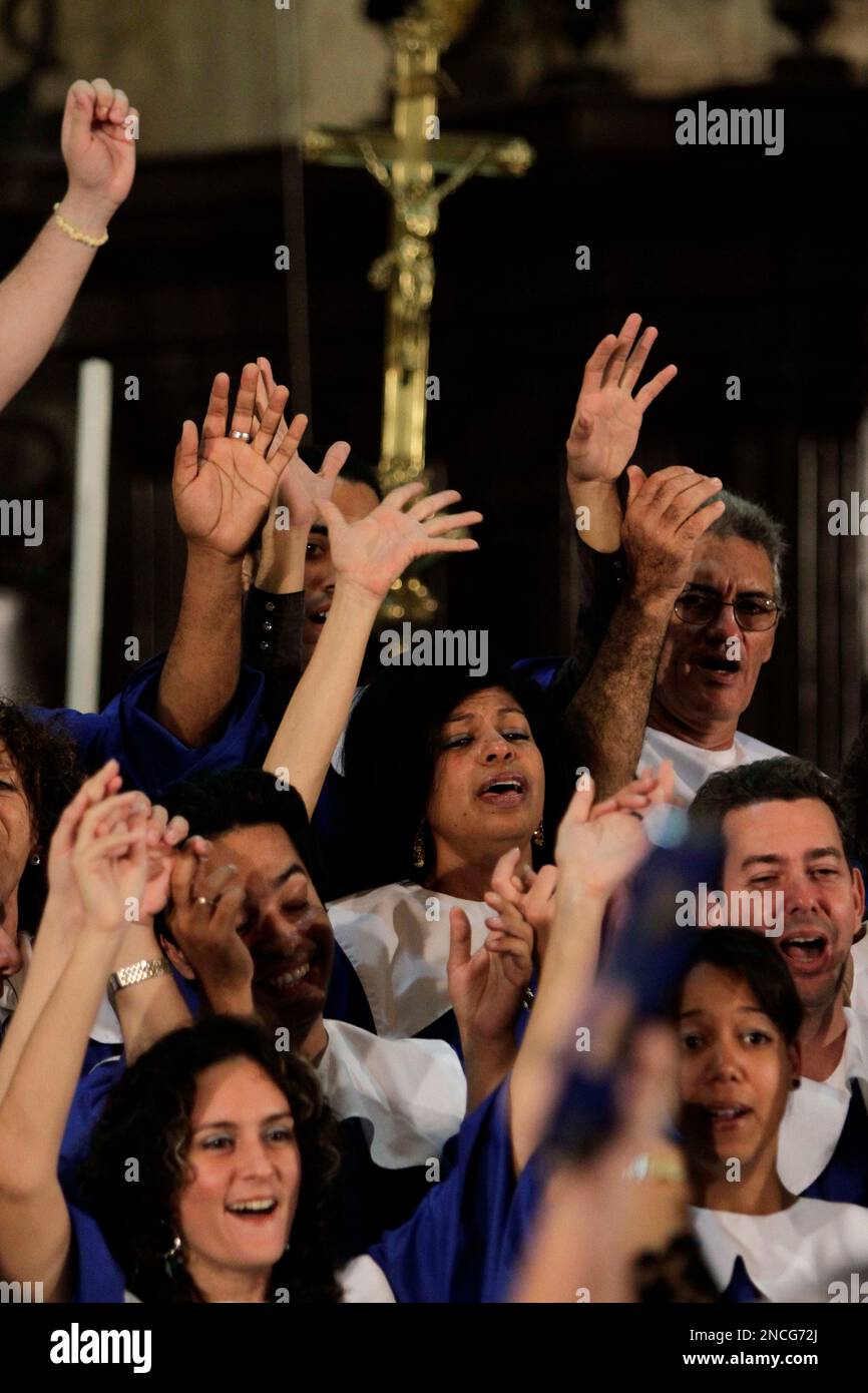 Members of the Schola Cantorum Coralina Juan Pablo II choir sing during ...