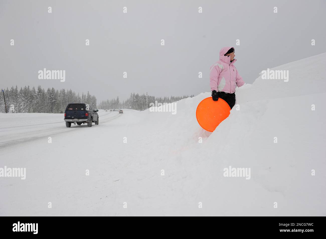 Colleen Kinder climbs down a huge bank of fresh snow after playing ...