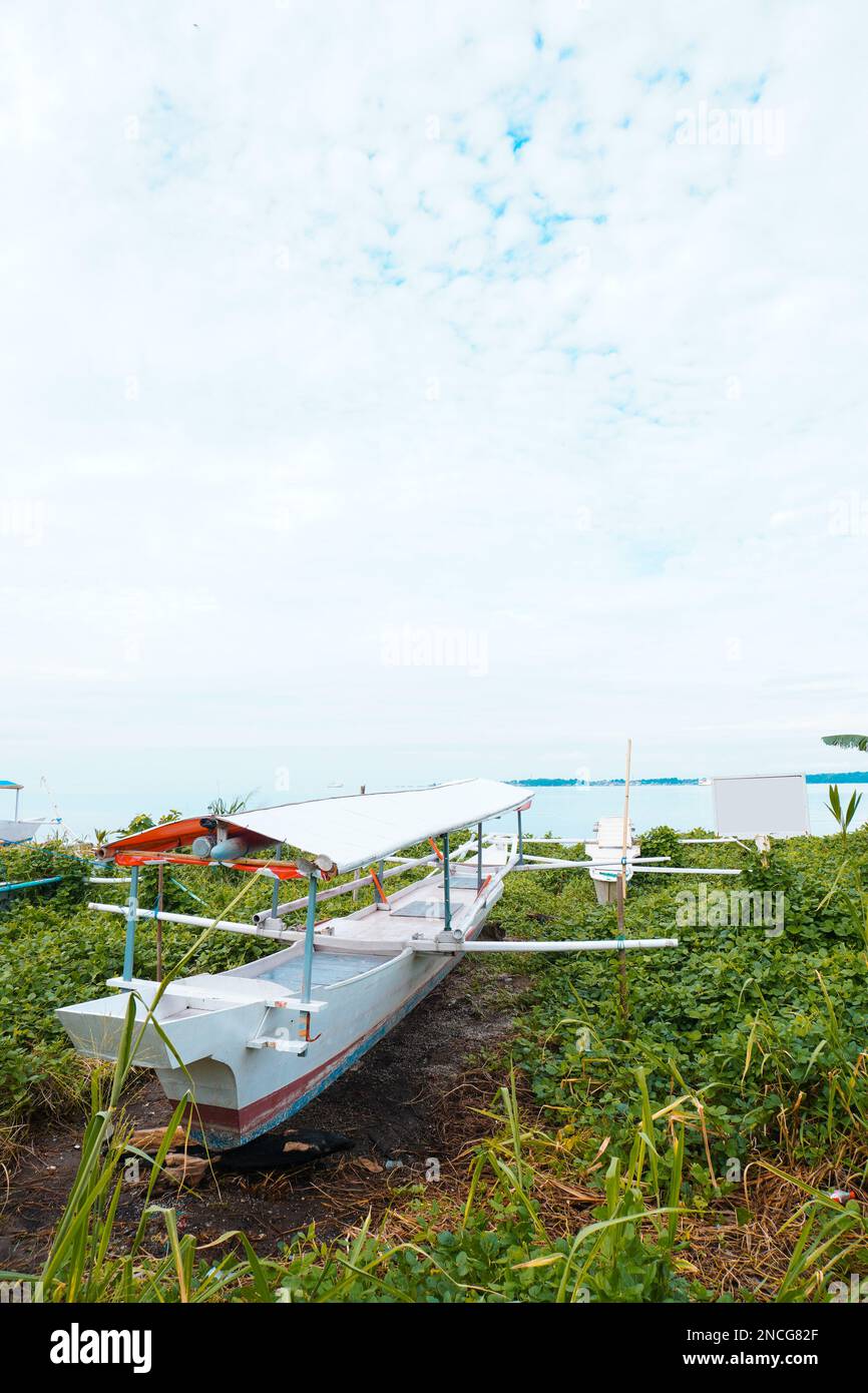 White boat anchored by river with blank sign Stock Photo - Alamy