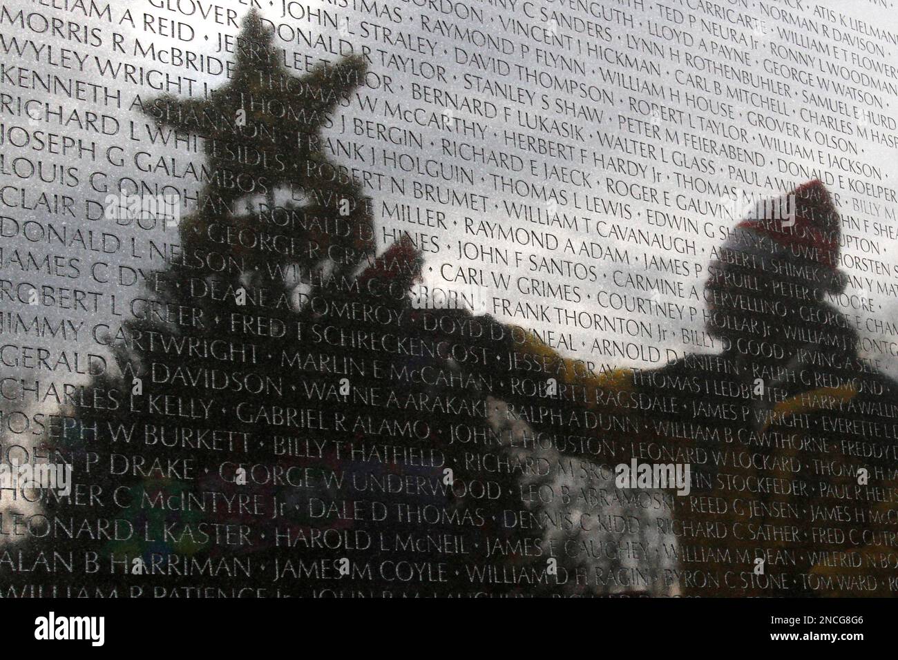Reflected in the Vietnam Veterans Memorial, Navy Vietnam Veteran Paul ...