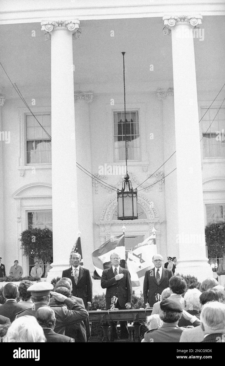 President Jimmy Carter is flanked by Egypt's President Anwar Sadat ...