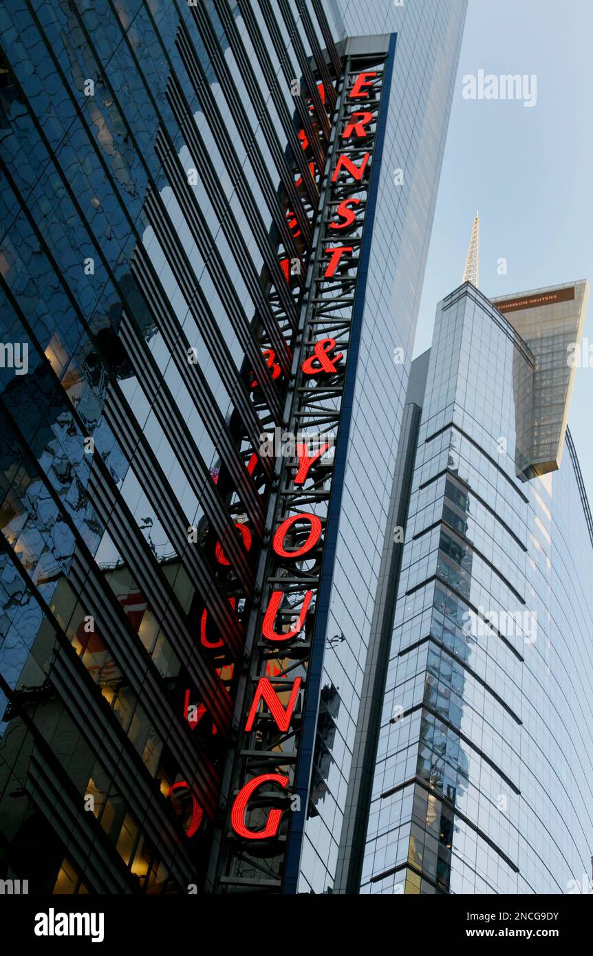 The Ernst & Young sign is reflected on the building's facade in New ...