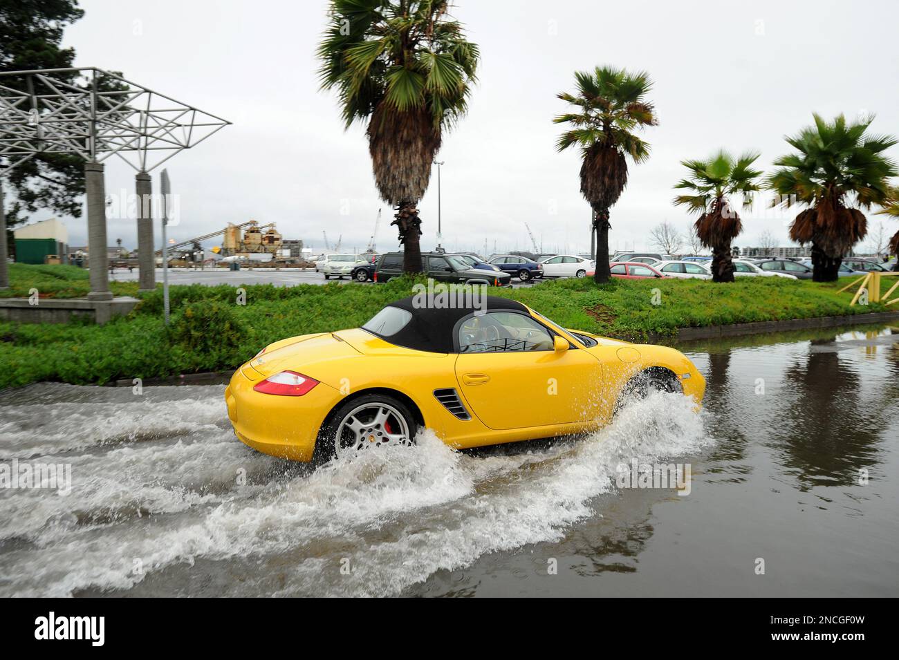 A Porsche navigates a flooded drive in Oakland, Calif., on Sunday, Dec ...