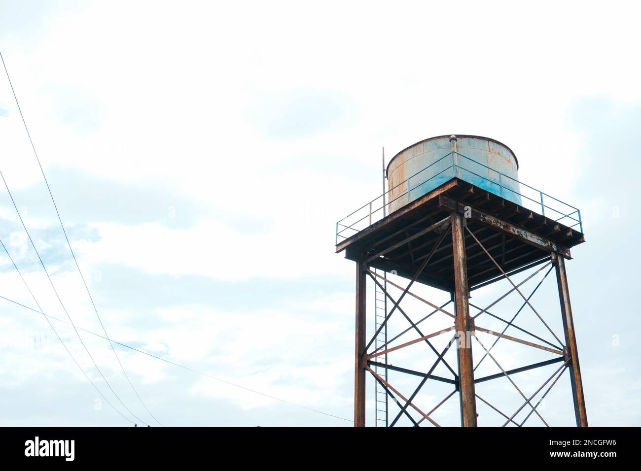 Looking up at the rusty old water tower from below against the ...