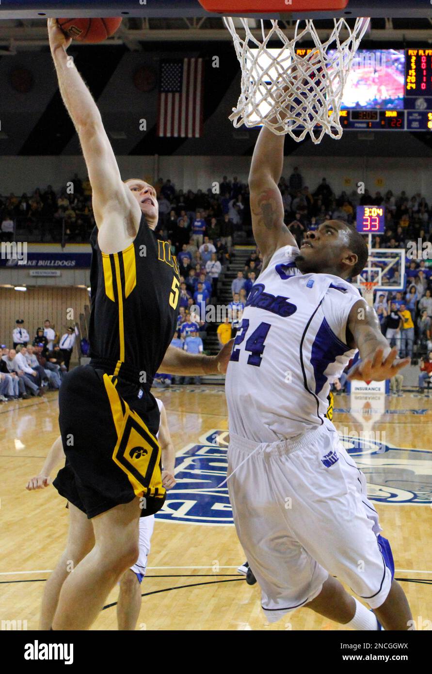 Iowa guard Matt Gatens, left, shoots over Drake guard Rayvonte Rice ...
