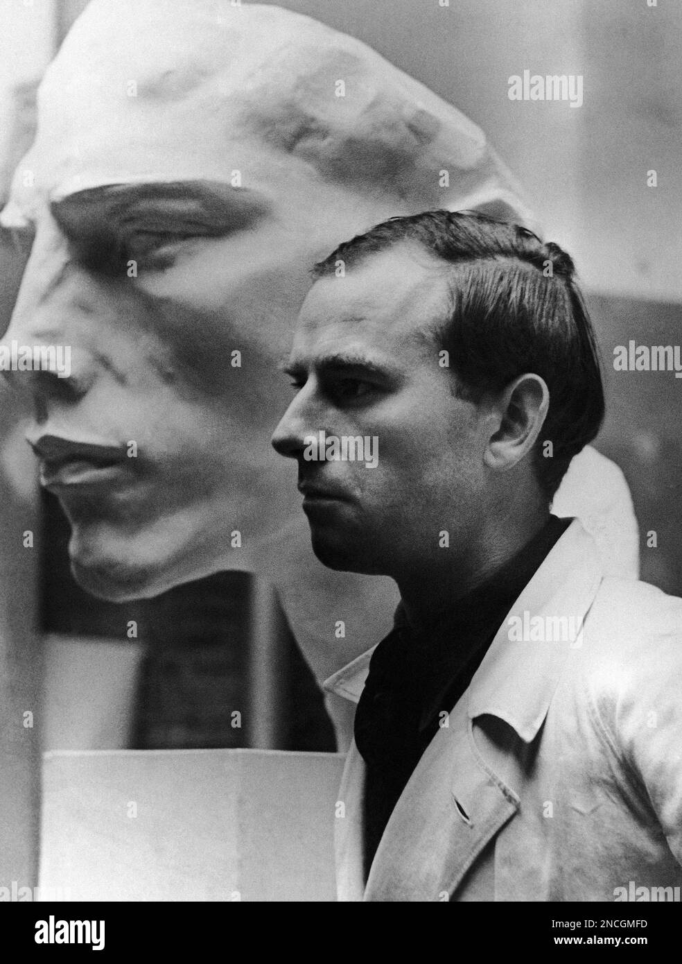German sculptor Arno Breker poses in front of a bust in his studio in ...
