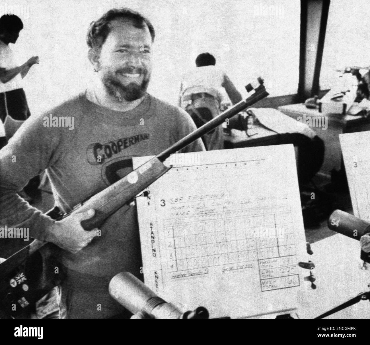 Malcolm Cooper of Great Britain shows off his scoreboard after winning ...