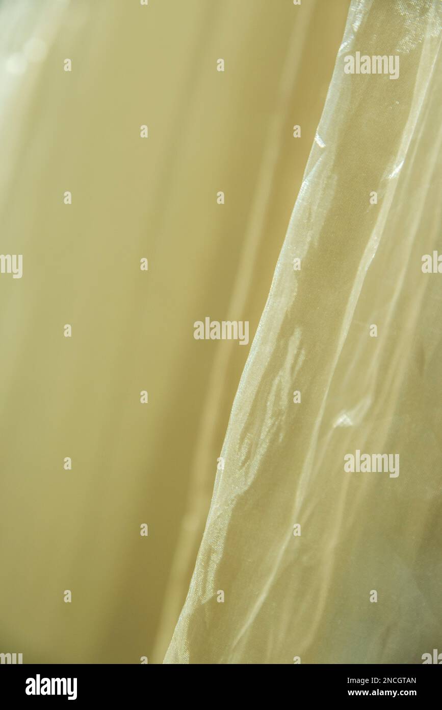 A gold curtain with diagonal lines in vertical or portrait format ...