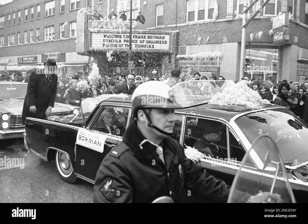 Astronaut Frank Borman waves from back seat of car during parade in his ...