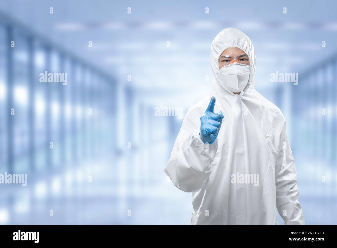Worker wears medical protective suit or white coverall suit with mask ...
