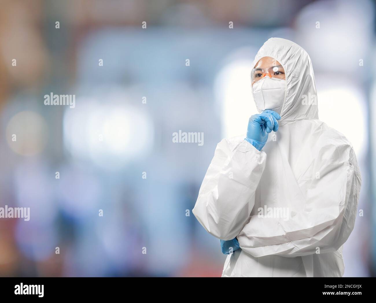 Worker wears medical protective suit or white coverall suit with mask ...